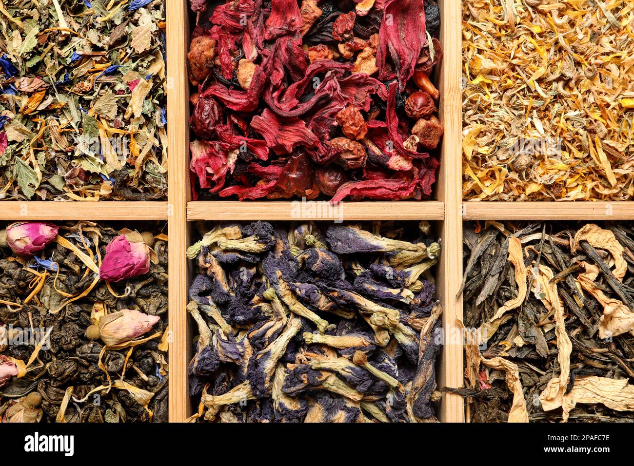 Different dry herbal teas in wooden box, top view Stock Photo - Alamy