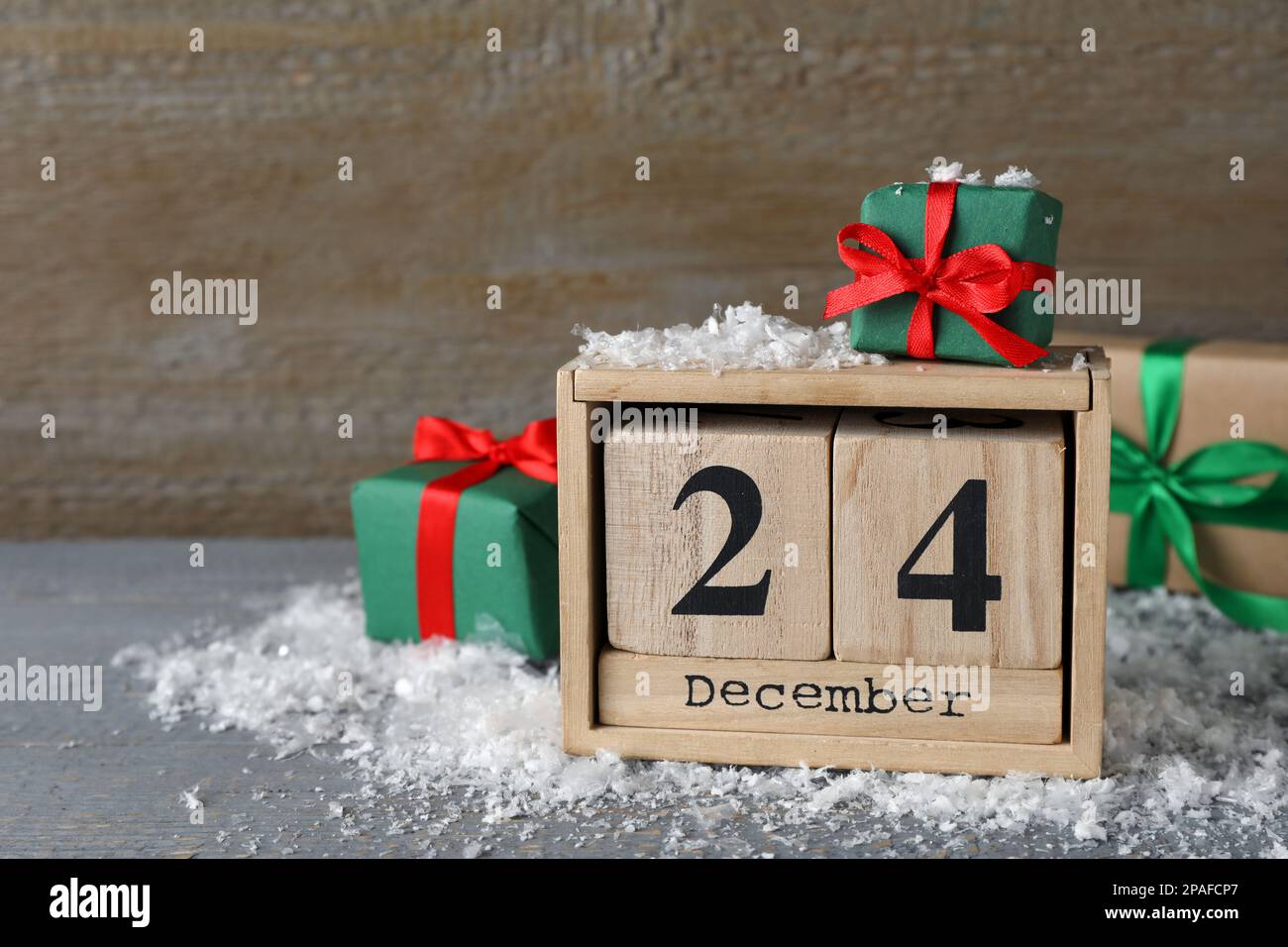 December 24 - Christmas Eve. Wooden block calendar and gift boxes on ...