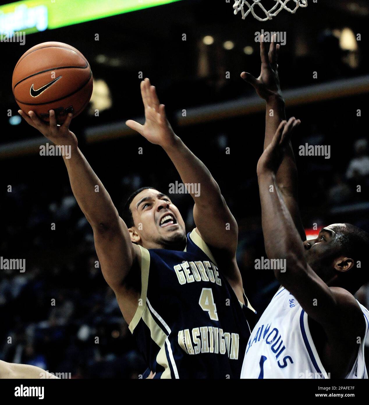 George Washington's Miles Beatty (4) shoots over Saint Louis' Danny ...