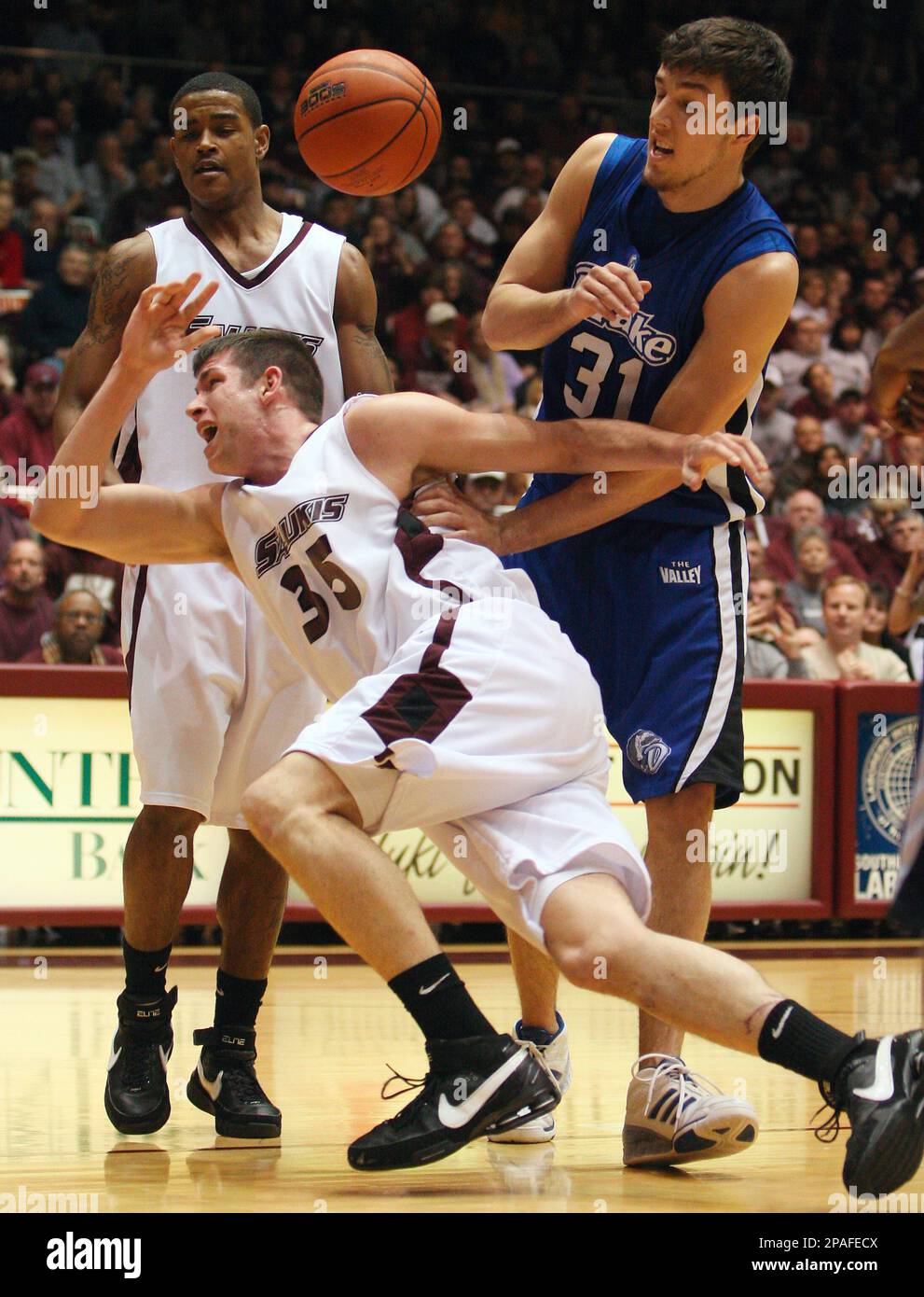 Southern Illinois' Tony Boyle loses the ball as he is pushed away by ...
