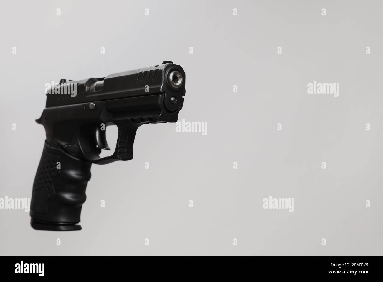 Standard handgun on light grey background. Semi-automatic pistol Stock ...