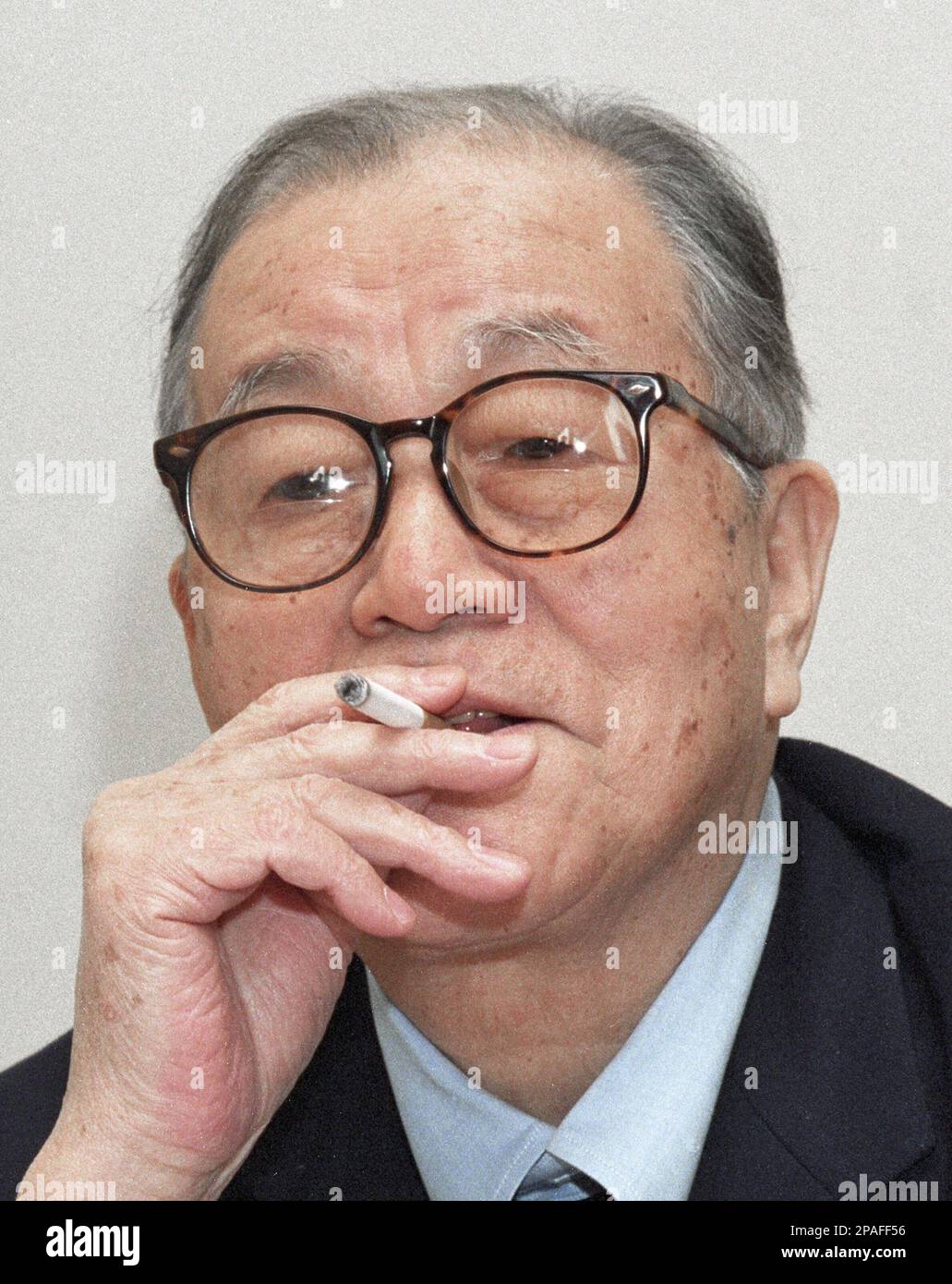 Japanese film director Kon Ichikawa puffs a cigarette during a press ...