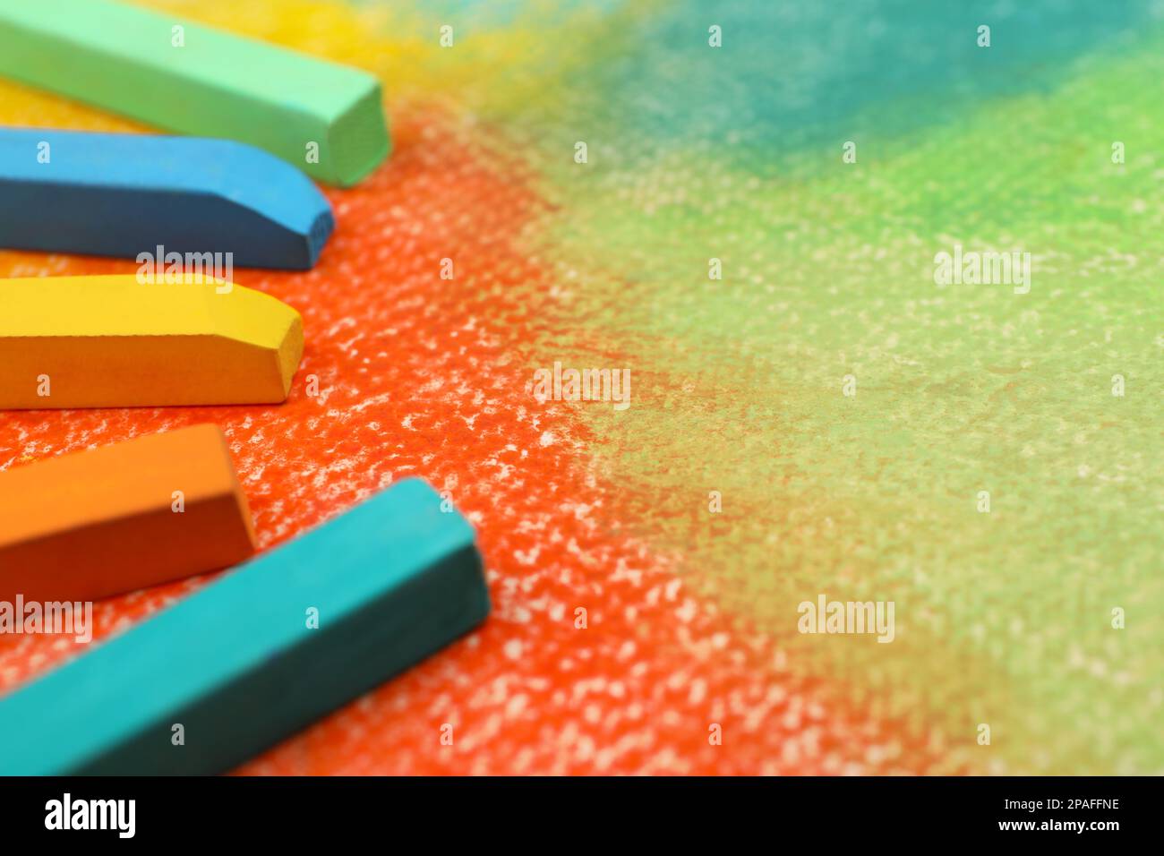 Colorful pastel chalks on abstract drawing, closeup. Space for text ...