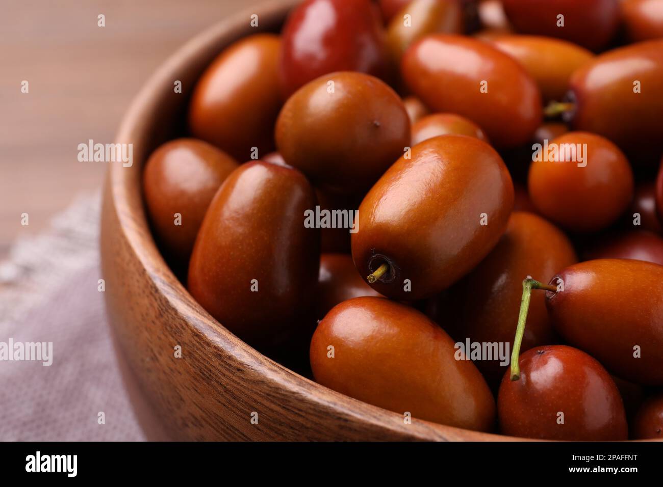 Fresh Ziziphus jujuba fruits in wooden bowl, closeup Stock Photo - Alamy