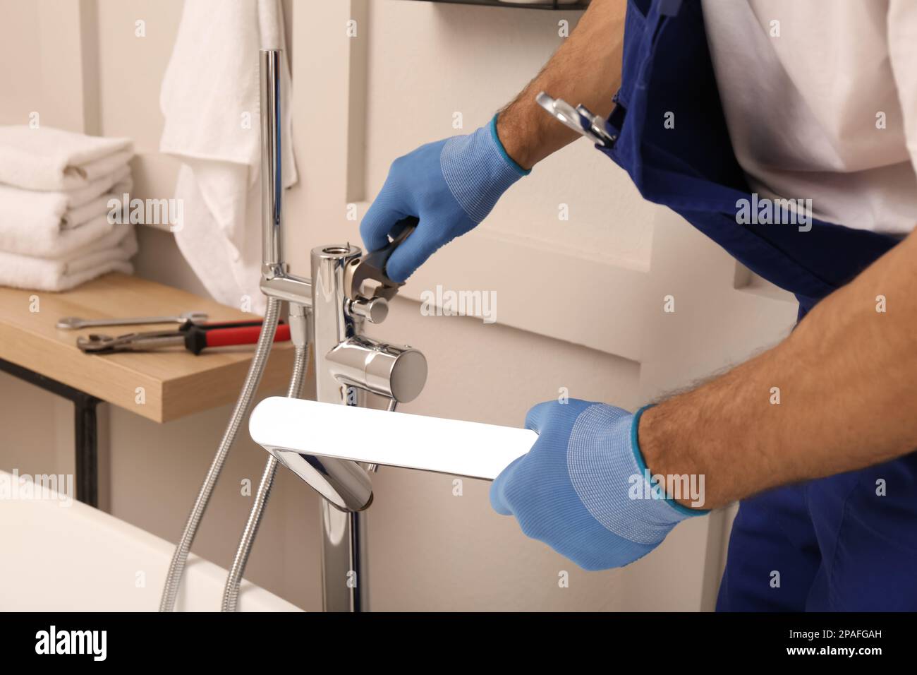 Professional plumber installing water tap in bathroom, closeup Stock ...