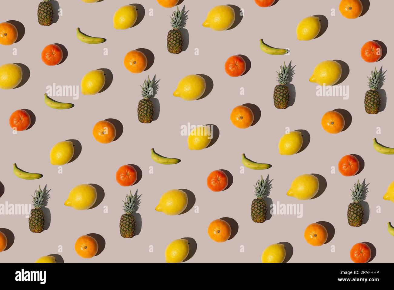 Creative isometric pattern made with tropical fruits on beige ...
