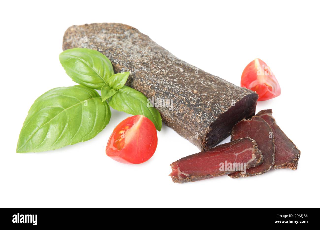 Delicious dry-cured beef basturma with basil and tomato on white ...