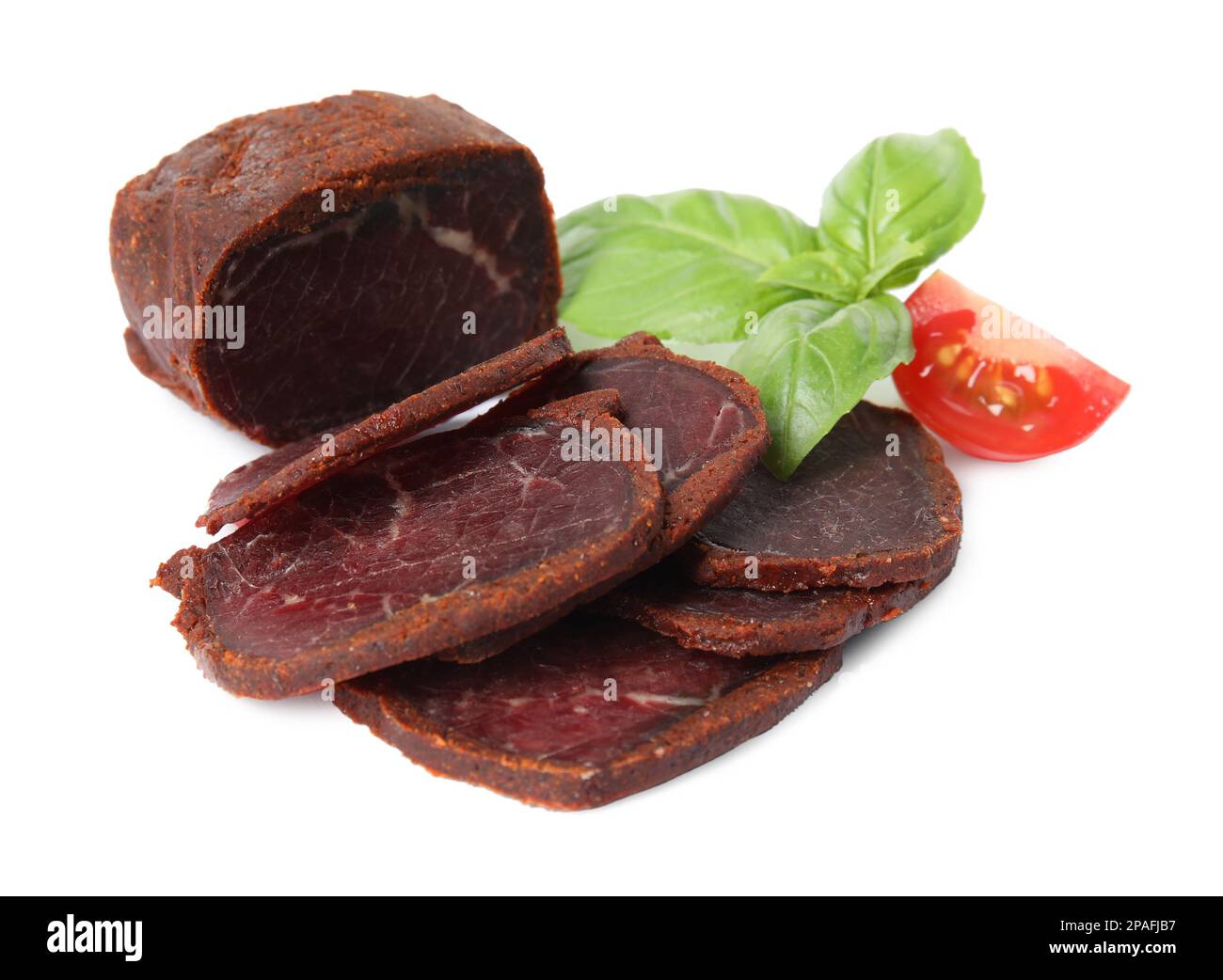 Delicious dry-cured beef basturma with basil and tomato on white ...