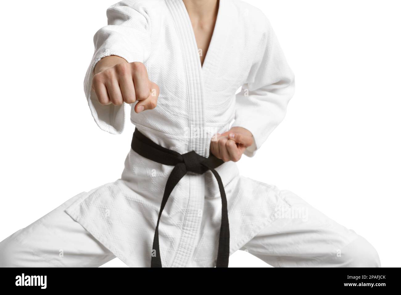 Martial arts master in keikogi with black belt against white background ...