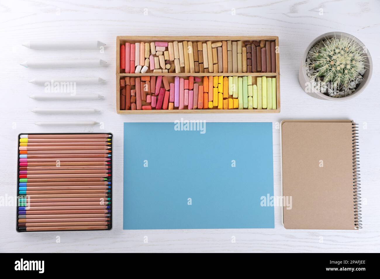 Layout with blank paper, soft pastels and other drawing supplies on ...