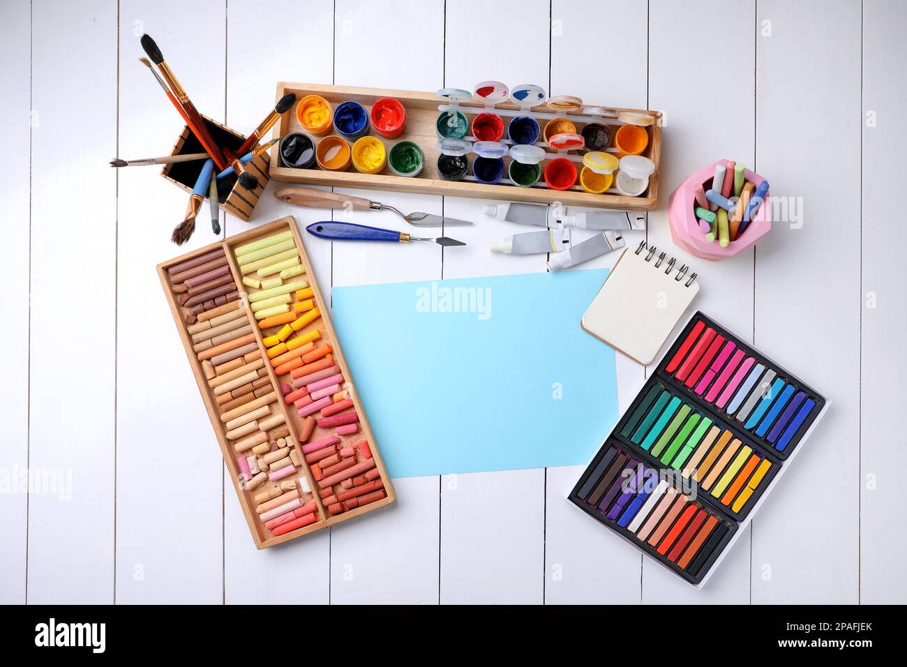 Blank sheet of paper, colorful chalk pastels and other drawing tools on ...