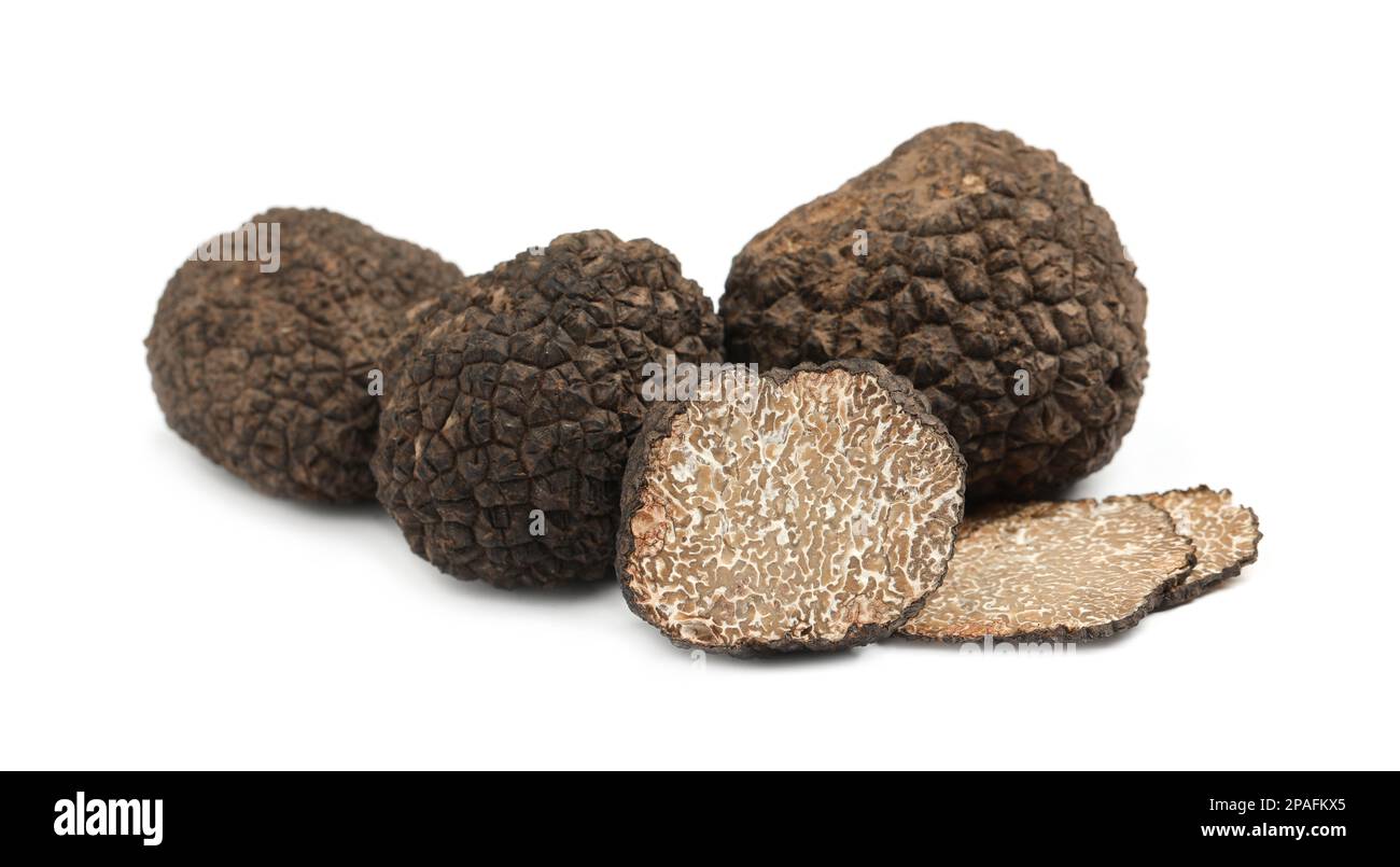 Cut and whole black truffles isolated on white Stock Photo - Alamy