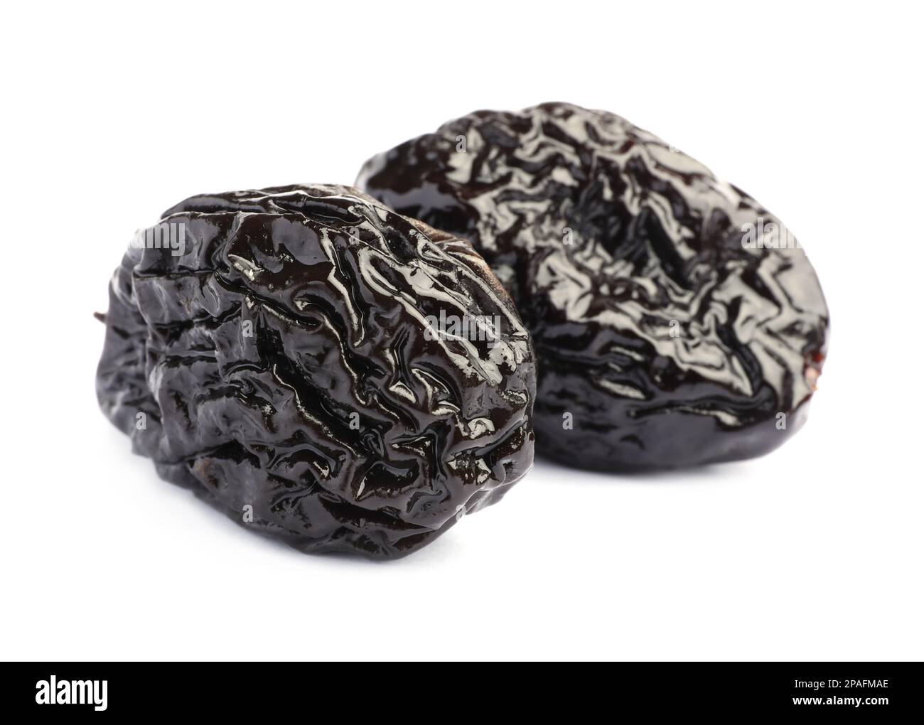 Sweet dried prunes on white background. Healthy snack Stock Photo - Alamy