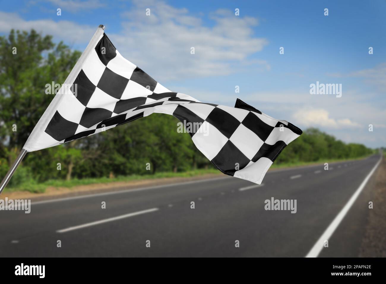 Checkered racing finish flag and asphalt road outdoors Stock Photo - Alamy