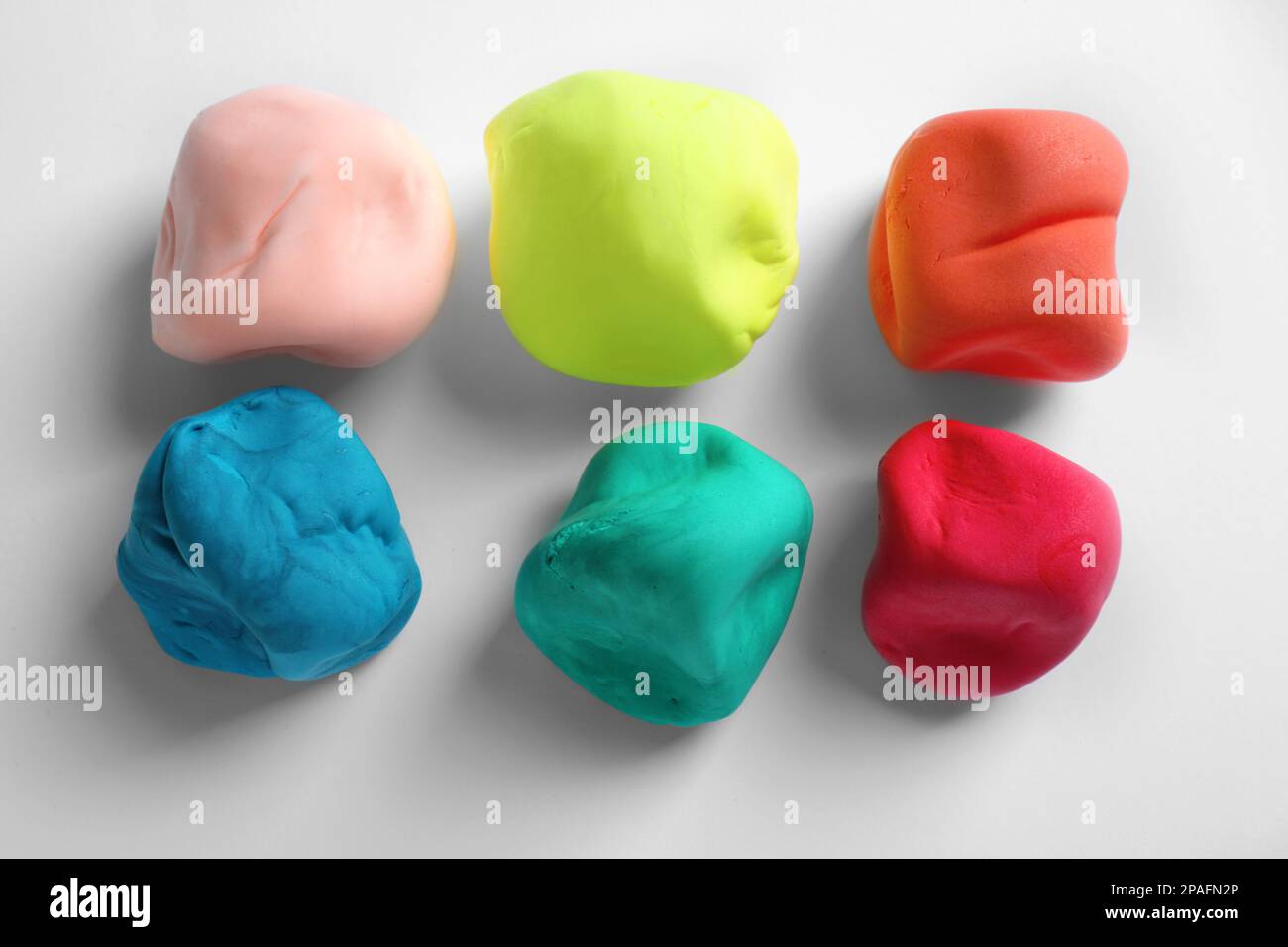 Different color play dough on white background, top view Stock Photo ...