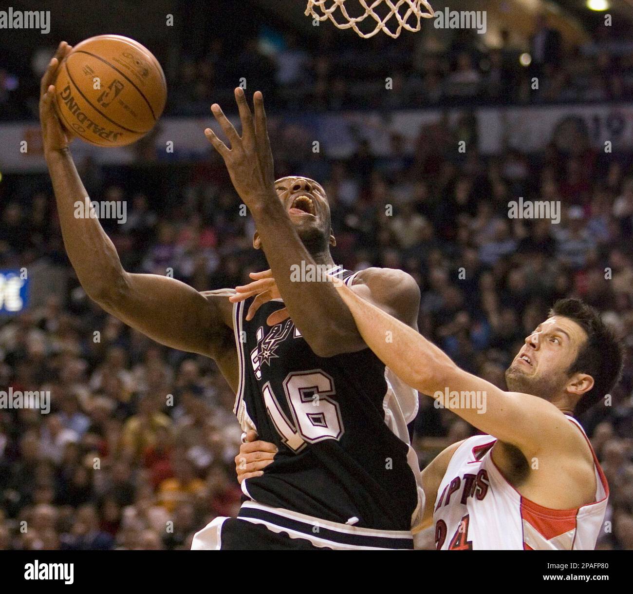Toronto Raptors forward Jason Kapono (24) fouls San Antonio Spurs ...