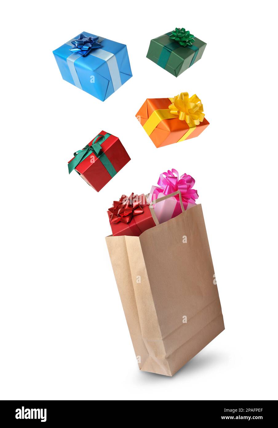 Many different gift boxes falling into paper shopping bag on white ...