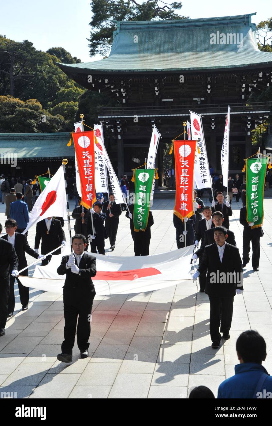 Nationalist group members holding a large national flag and banners ...