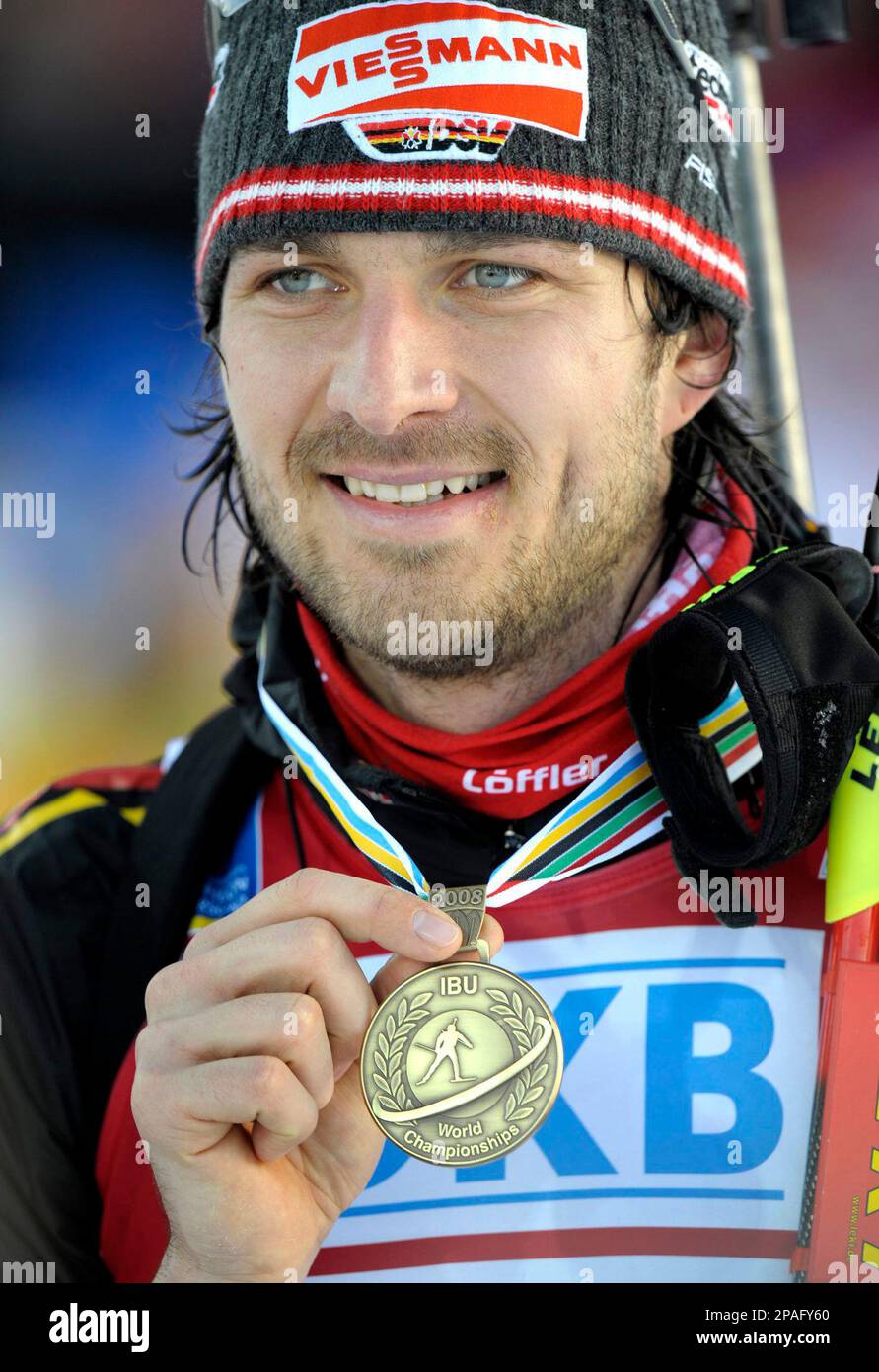 Alexander Wolf of Germany shows off his bronze medal after the 12.5 km ...