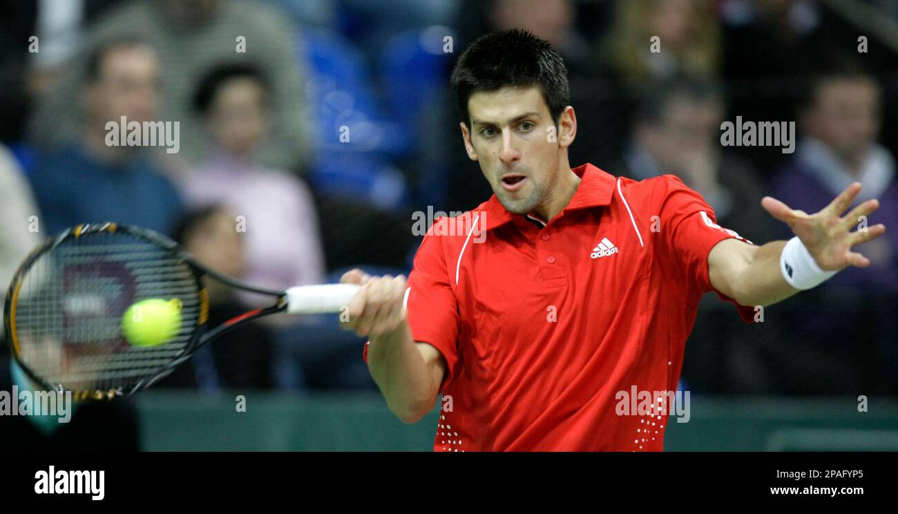 Novak Djokovic of Serbia returns a ball to Nikolay Davydenko of Russia ...