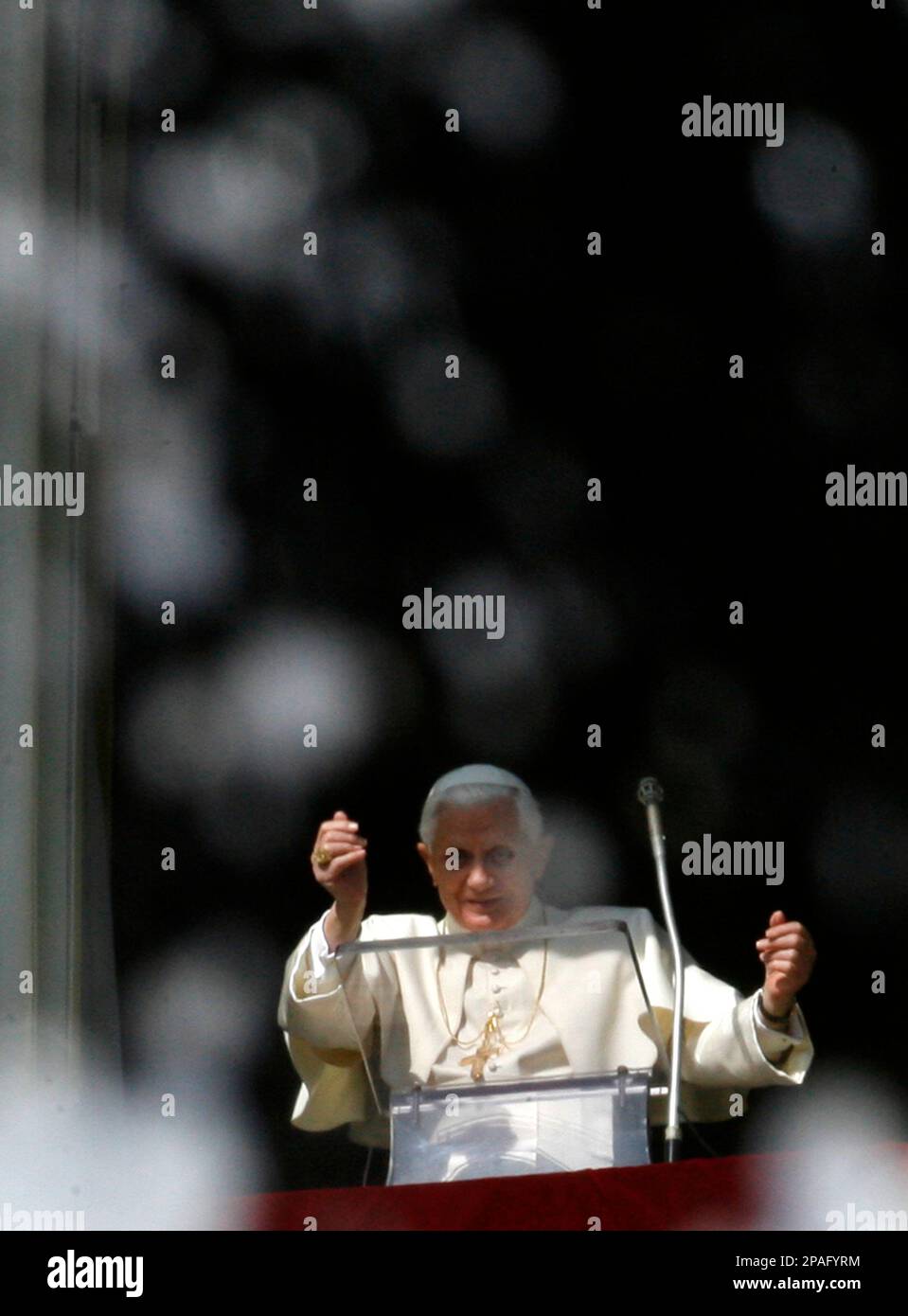 Pope Benedict XVI waves to pilgrims and faithful from the window of his ...