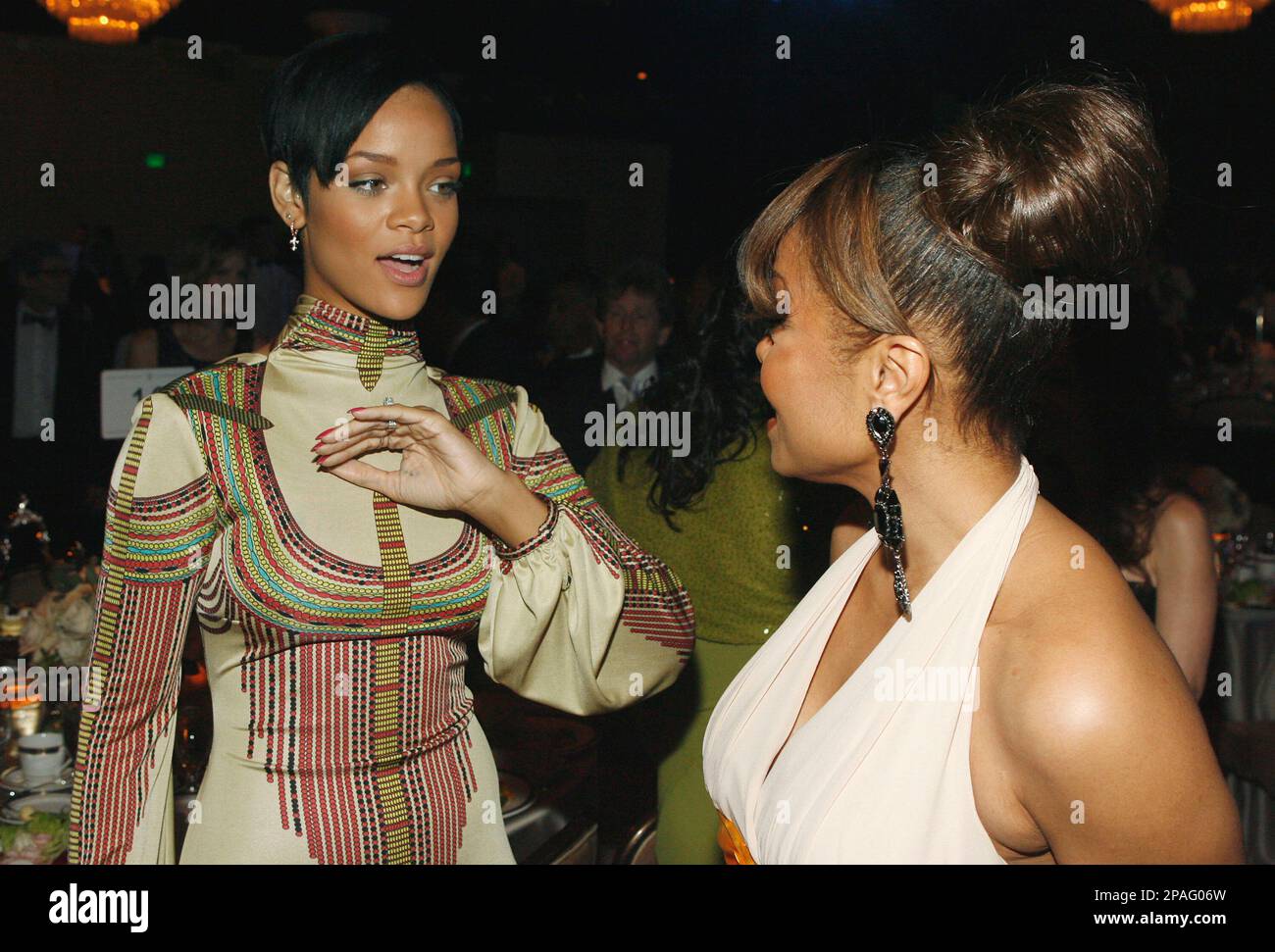 Rihanna, left, and Janet Jackson talk to each other at the Clive Davis ...