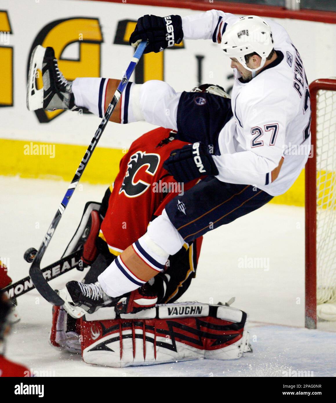 Edmonton Oilers' Dustin Penner, right, crashes over Calgary Flames ...