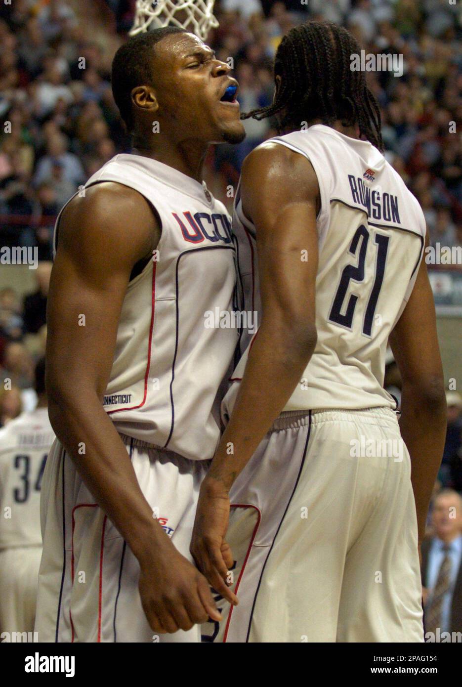 Connecticut's Jeff Adrien, left, and Stanley Robinson, react during the ...