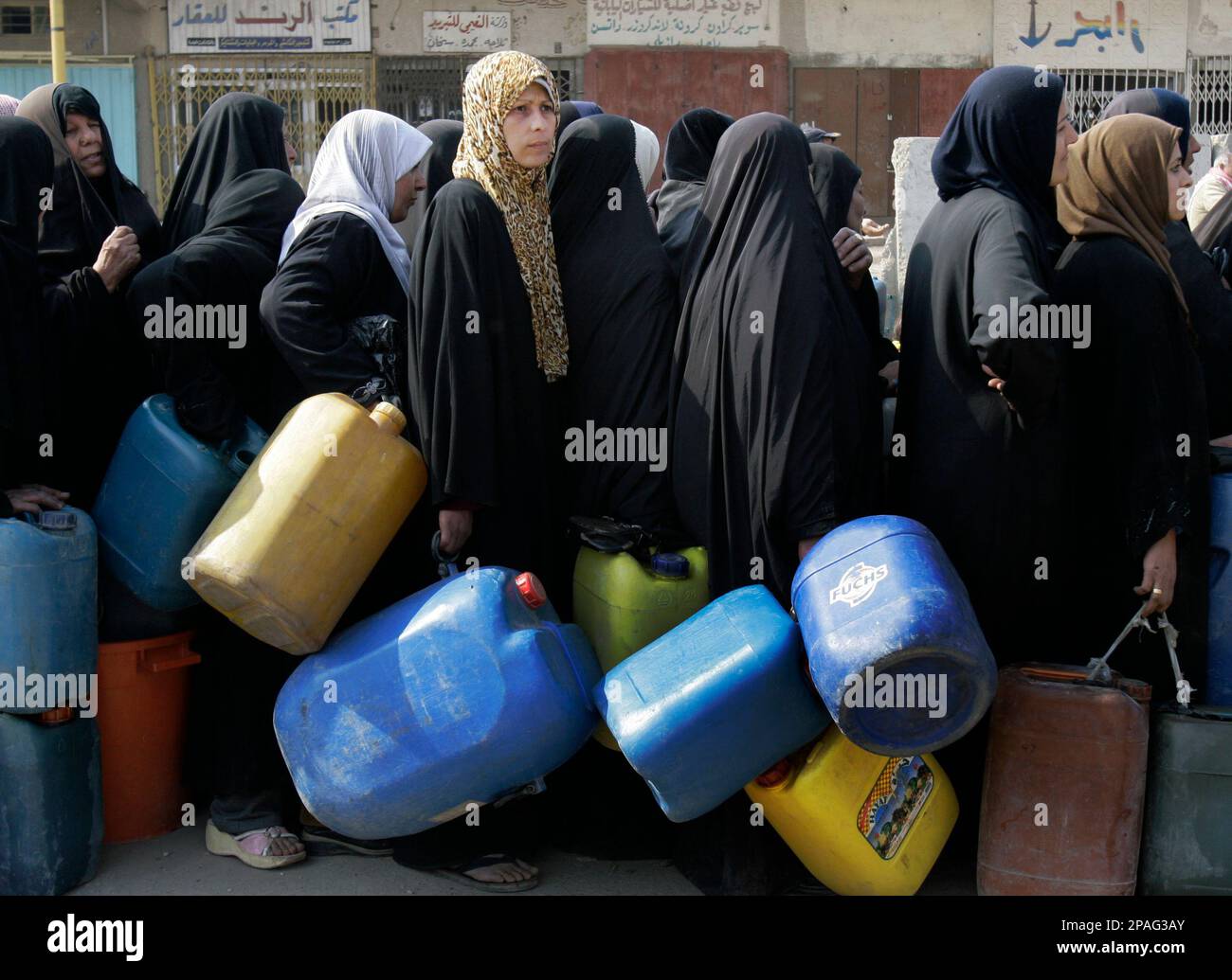 Iraqi women line up to buy rationed cooking oil, Saturday, Feb. 9, 2008 ...