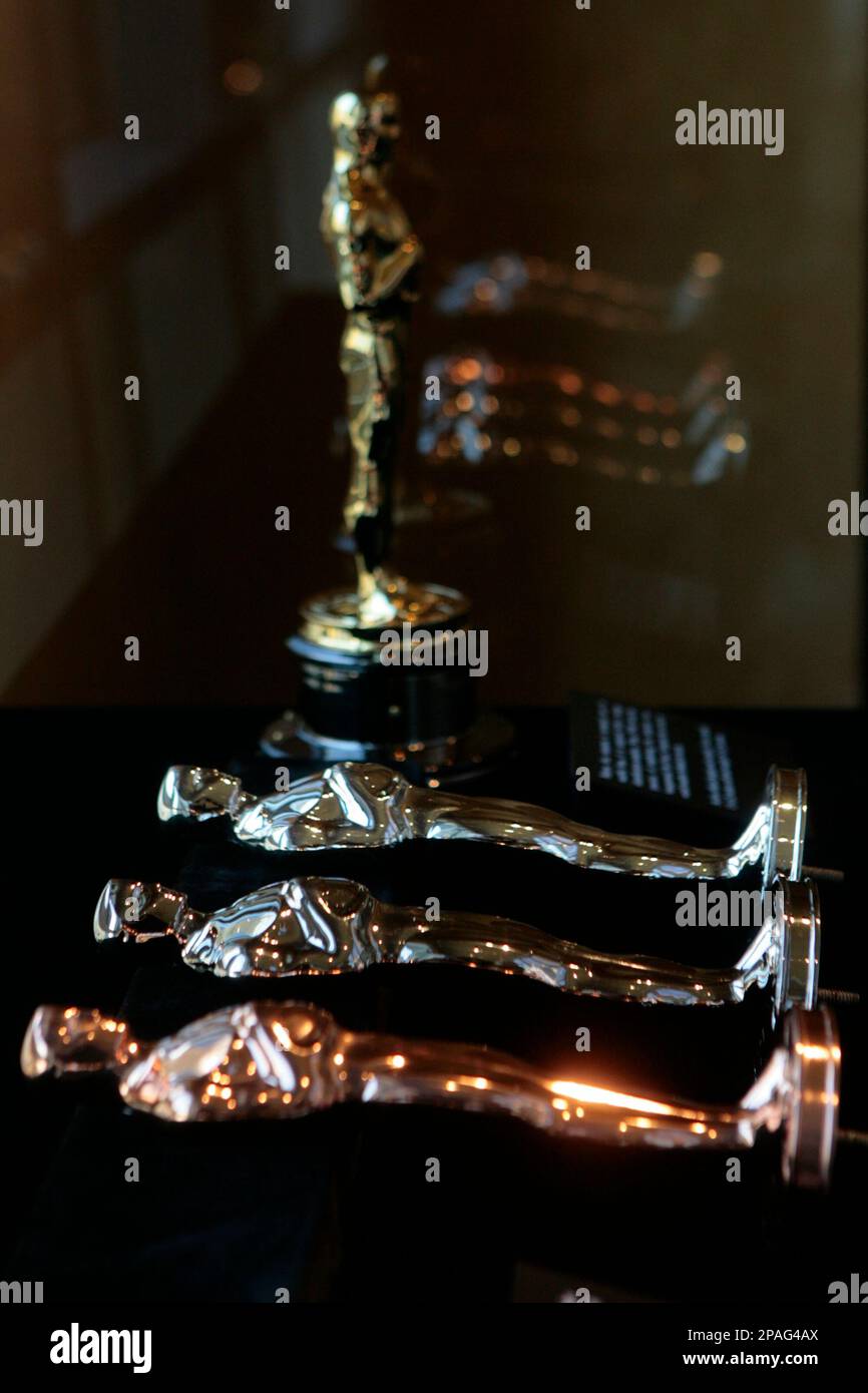 Unfinished metal Oscar statuettes are displayed along fifty Oscar ...