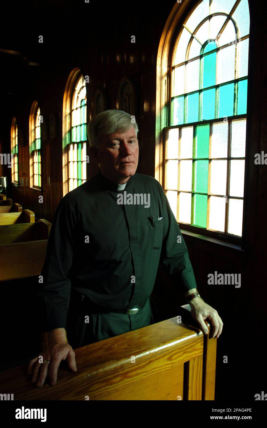 Father Michael Kavanaugh of Our Lady of Lourdes church stands in his ...