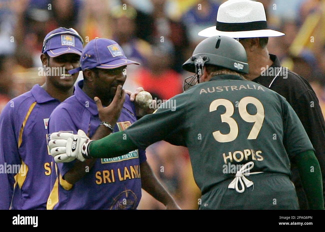 Australia's James Hopes, right, checks on Sri Lanka's Muttiah ...