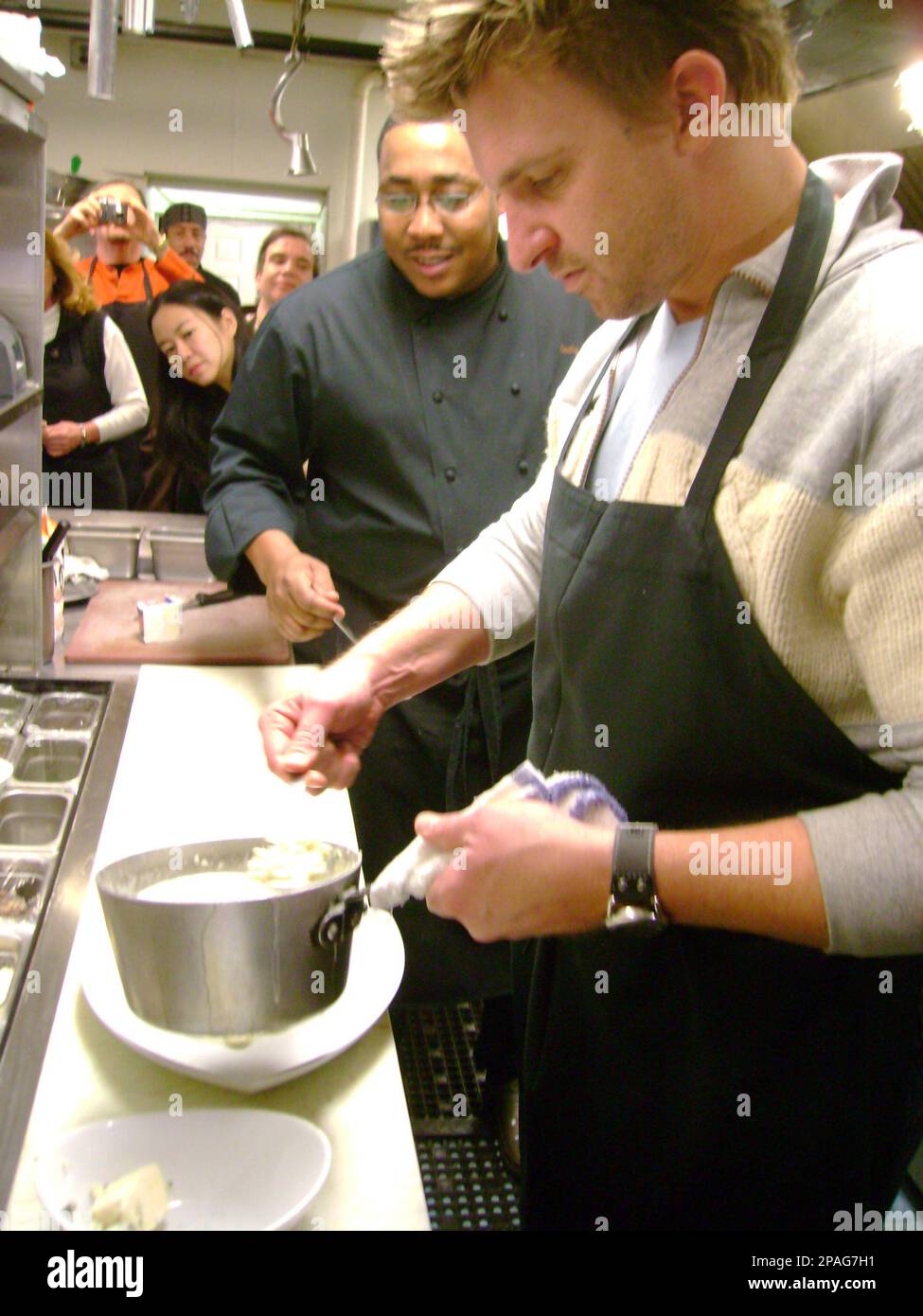 Baltimore chef Timothy Dean, right, shows Ryan Black how to make black ...