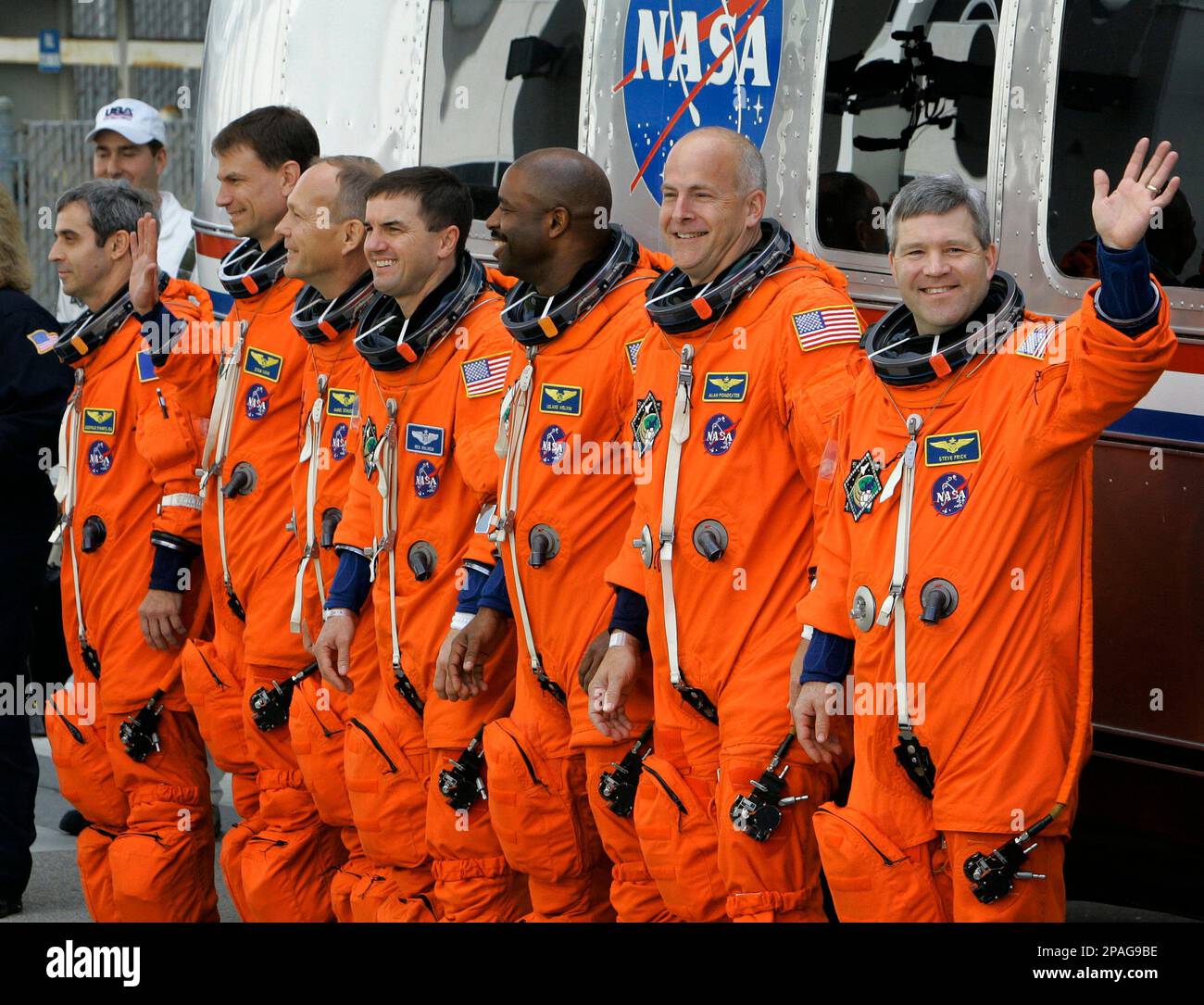 STS-122 commander Steve Frick, right, waves to members of the media as ...