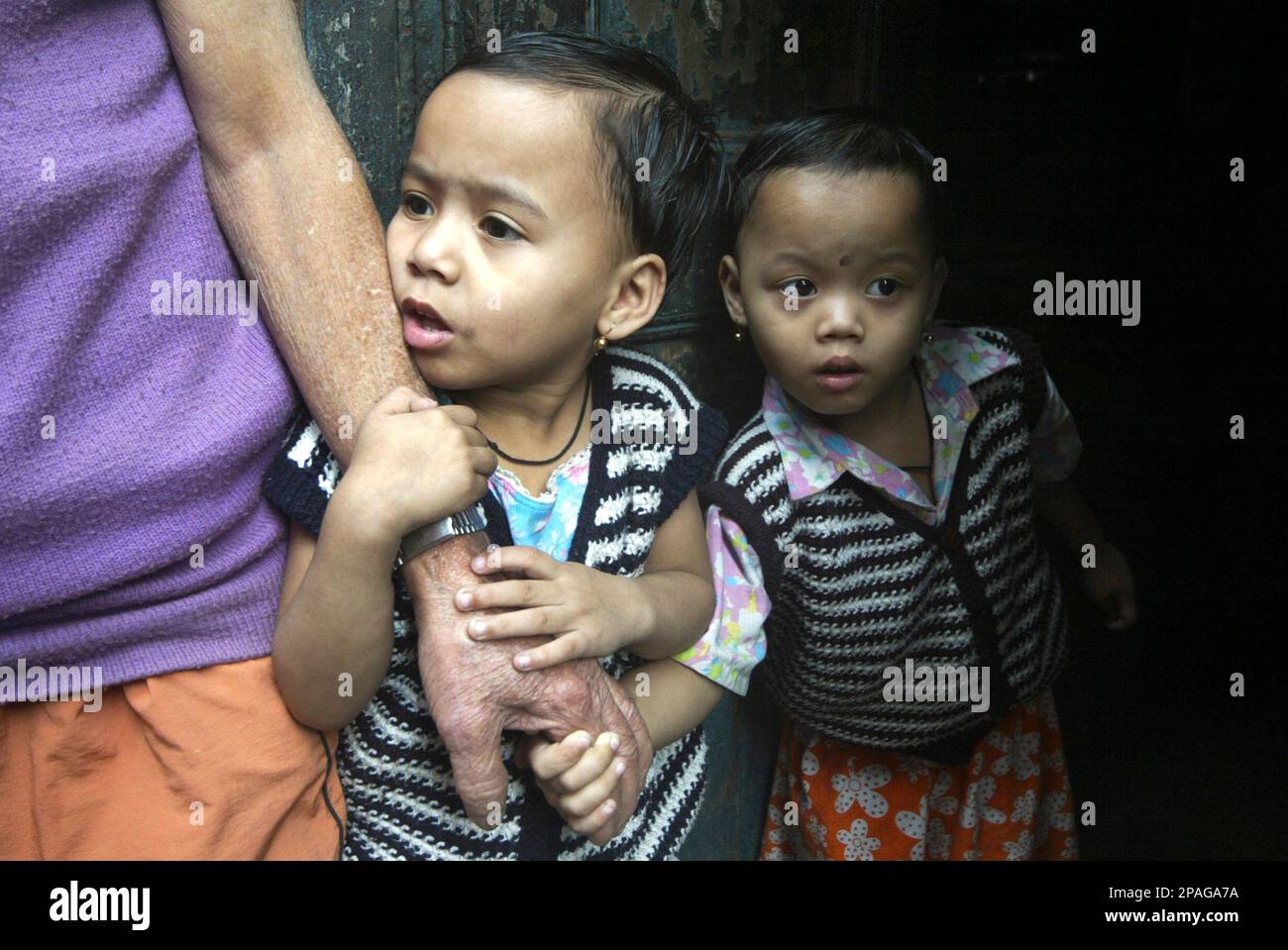 Members of the Chinese community living in Calcutta watch a dragon mask ...