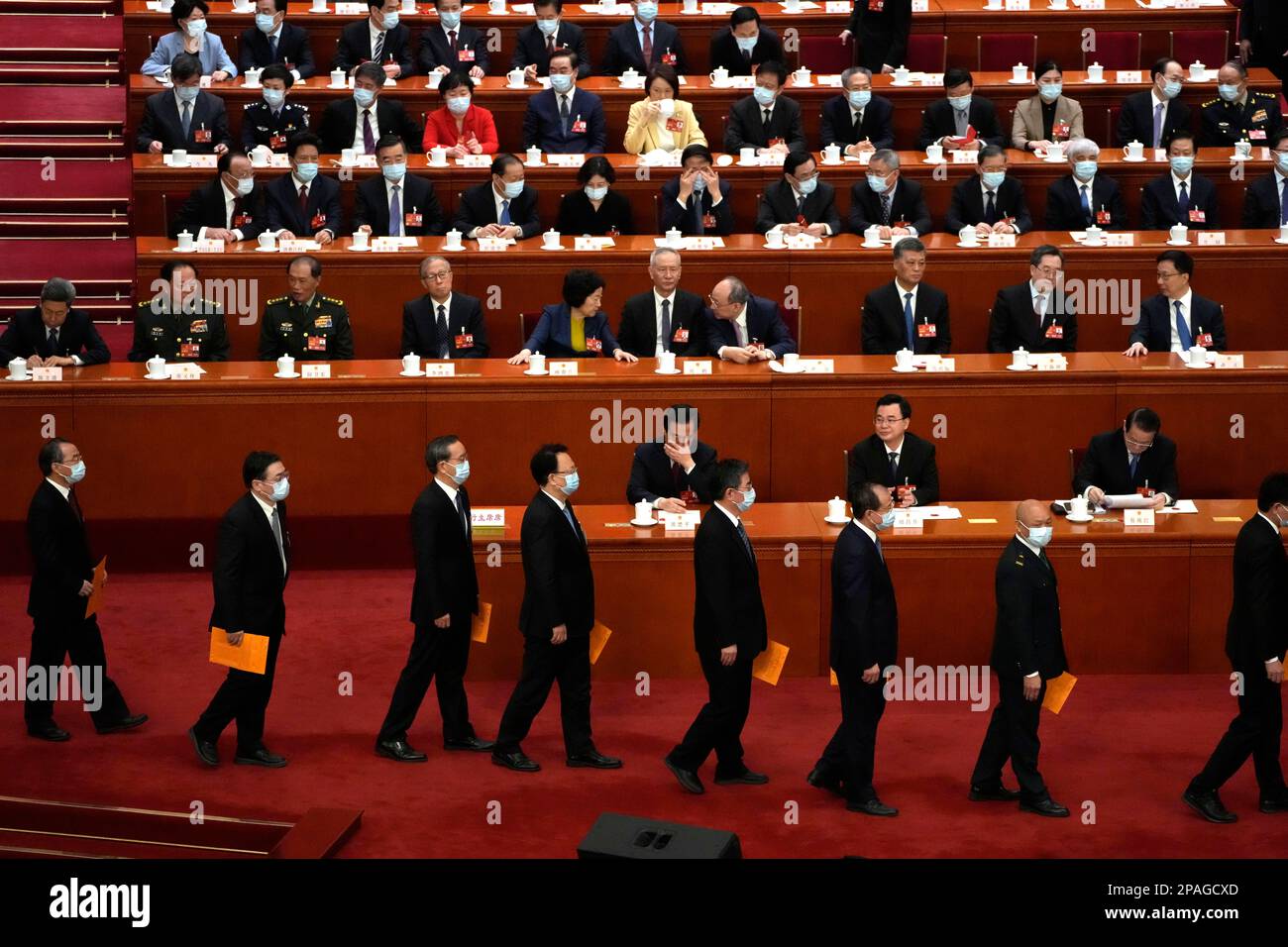 Delegates line up to cast their votes during a session of China's ...