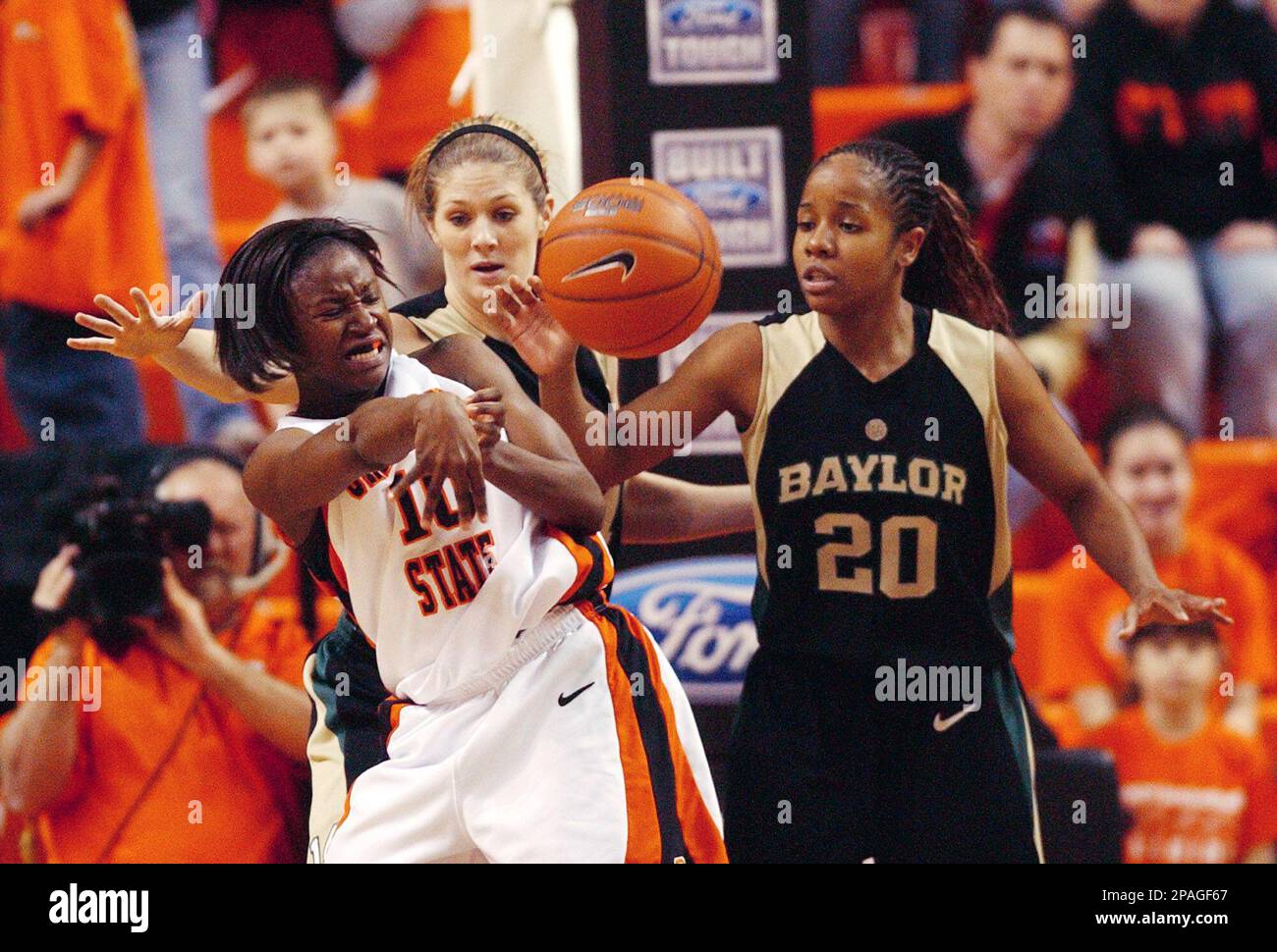 Oklahoma State guard Andrea Riley, front, passes the ball to a teammate ...