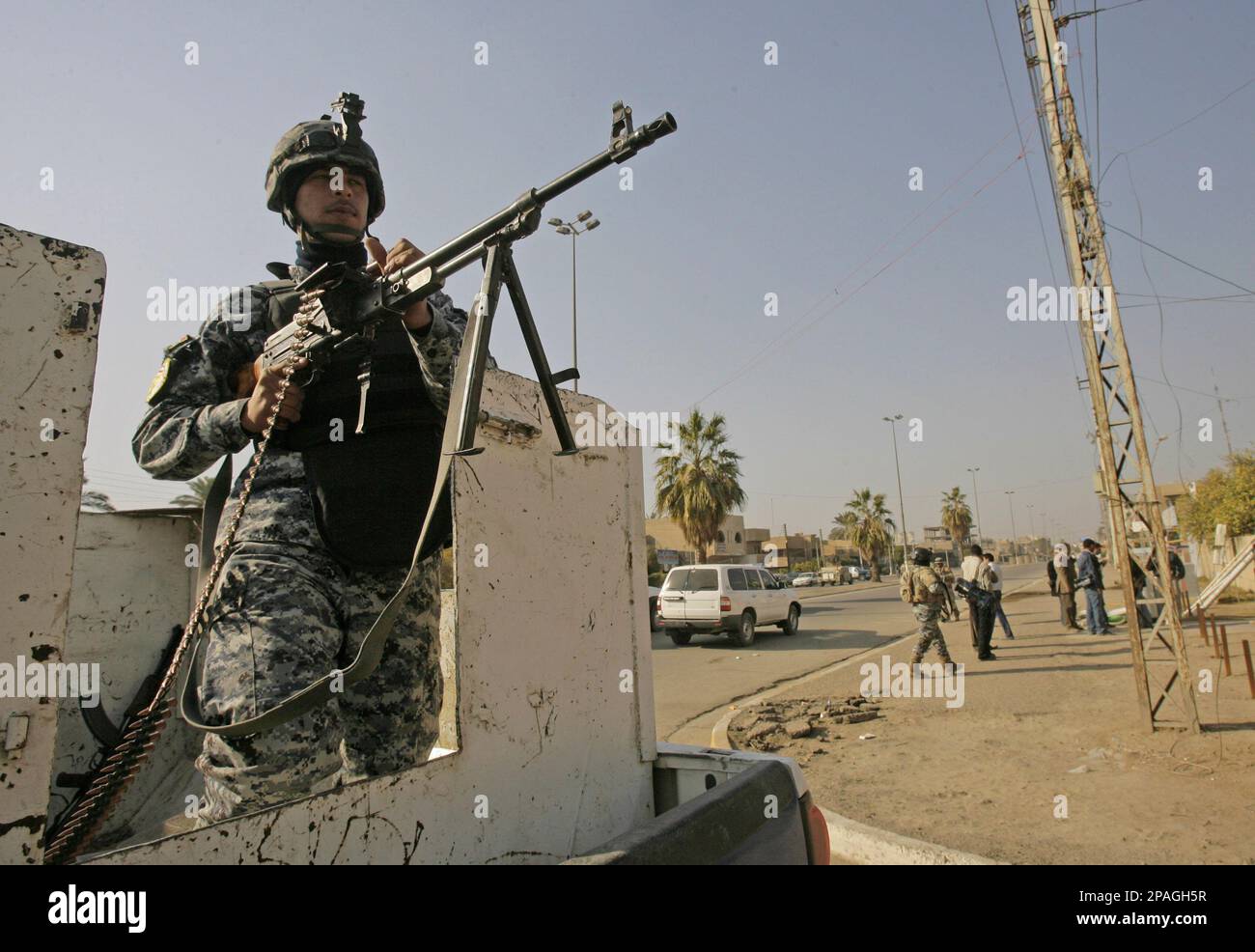 Iraqi national police officers patrol the predominantly Sunni ...