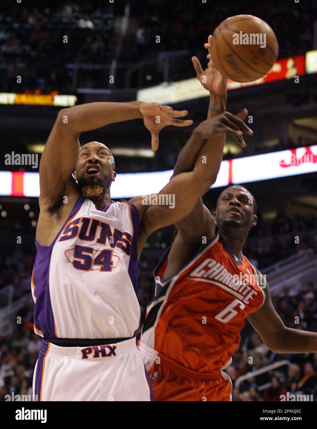 Phoenix Suns forward Brian Skinner, left, is fouled by Charlotte ...