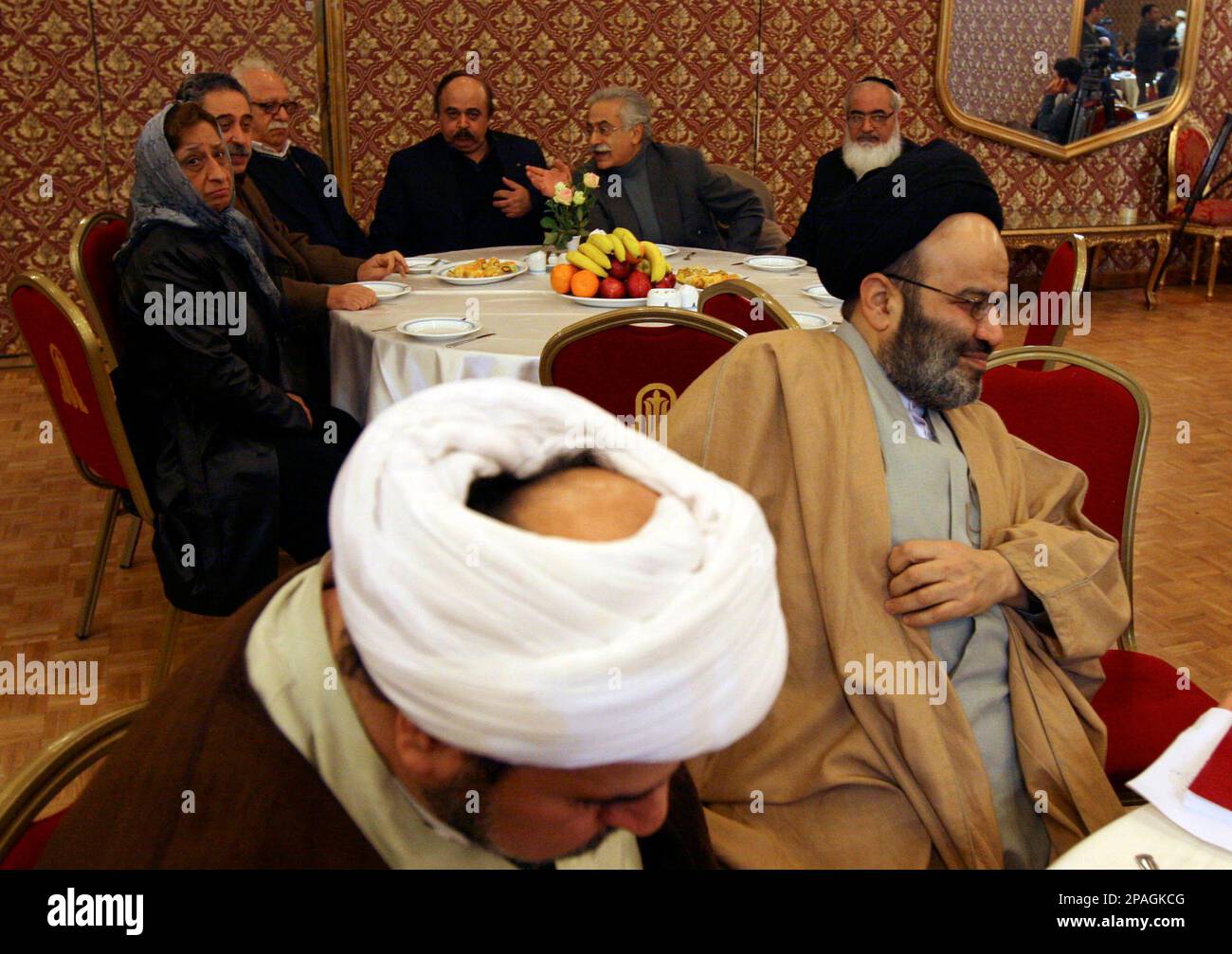 Iranian clerics laugh in the foreground as Iranian Jewish Committee ...
