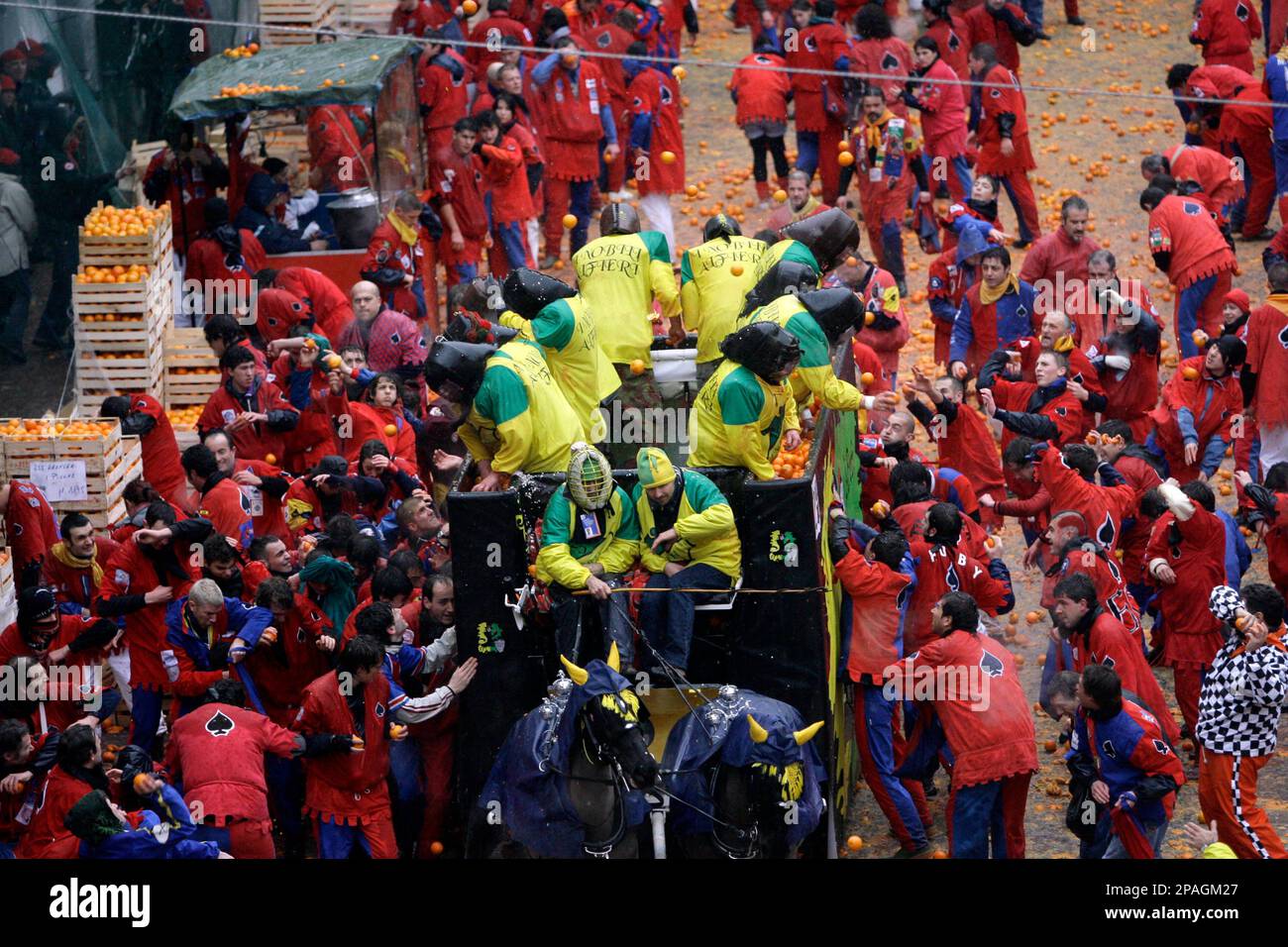 People throw oranges as part of Carnival celebrations in the northern ...