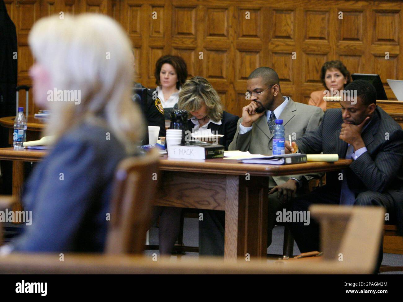 former Canton patrolman Bobby Cutts Jr., 30, center at table, listens ...