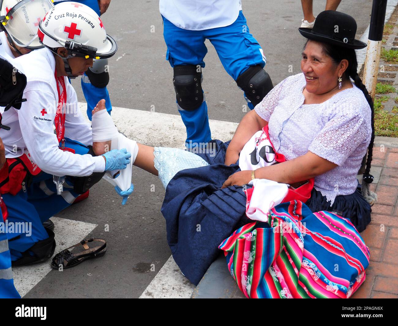 Indigenous woman is treated by paramedics from the Peruvian Red Cross ...