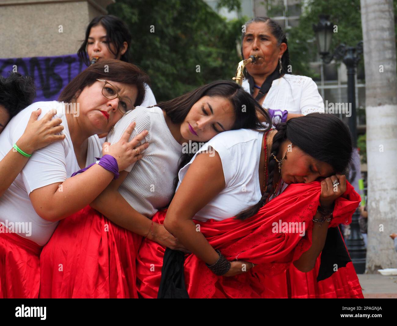 Women activists dressed in red and white performing when hundreds of ...
