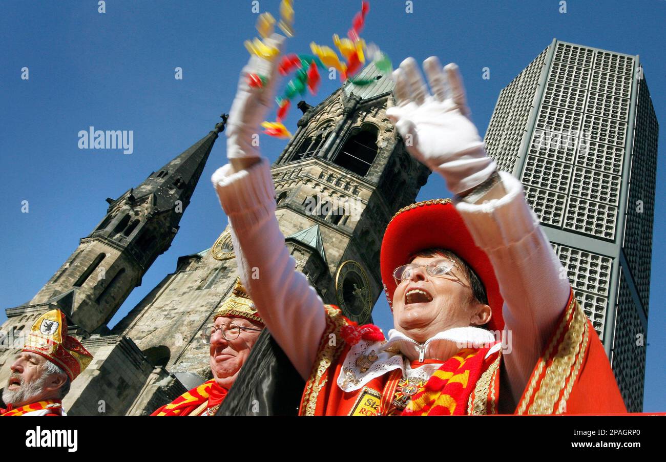 A woman throws candy during the carnival parade in front of Kaiser ...