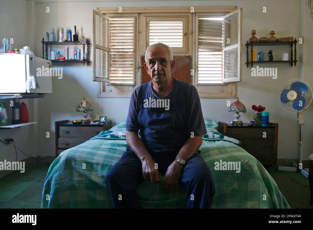 ** FILE ** Pedro Llera sits in his bedroom in the home where he lives ...