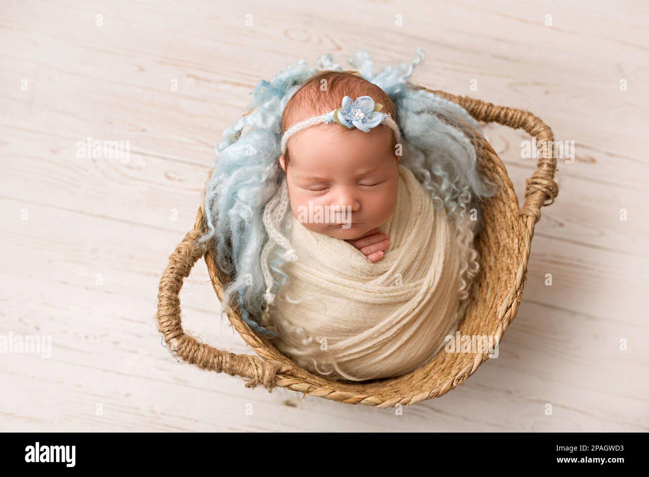 Top view of a newborn baby girl sleeping in a white wrap with a blue bandage Stock Photo - Alamy