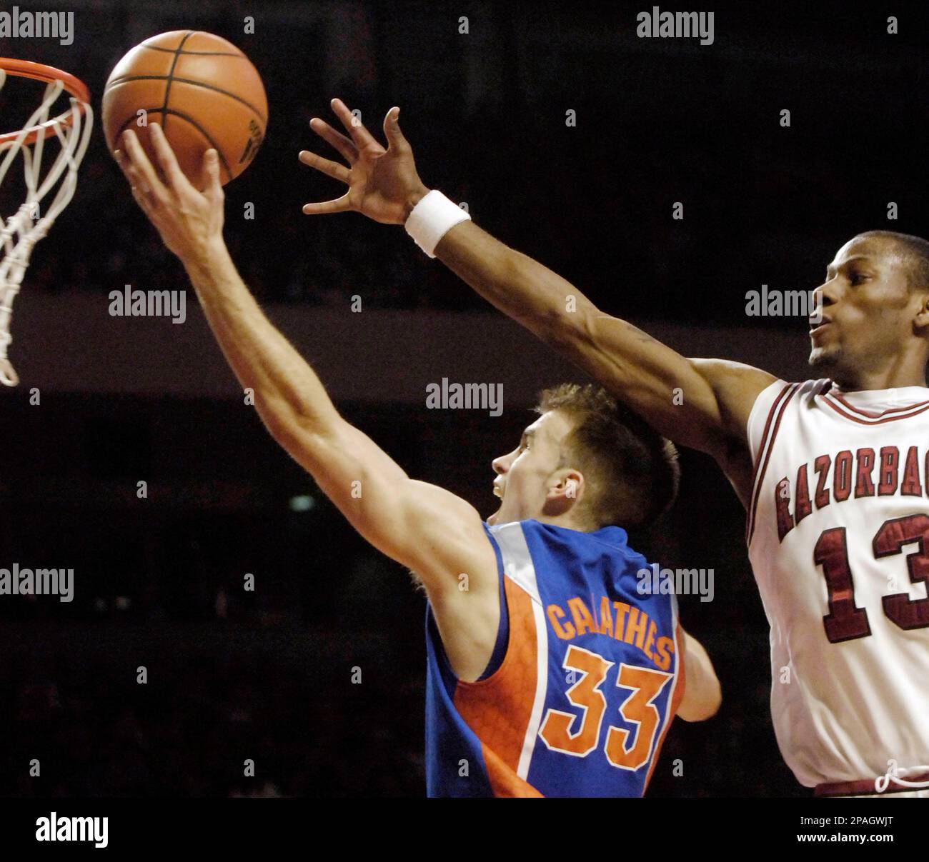 Arkansas' Sonny Weems, right, attempts to block a shot made by Florida ...
