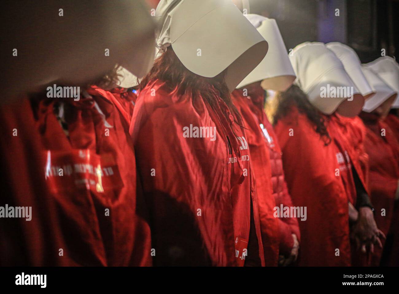 Jerusalem, Israel. 11th Mar, 2023. Female protesters wear red robes and ...