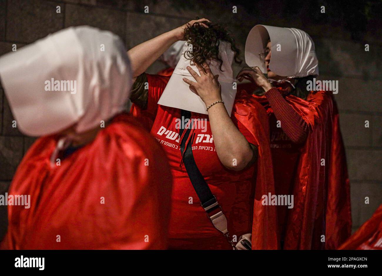Jerusalem, Israel. 11th Mar, 2023. Female protesters wear red robes and ...